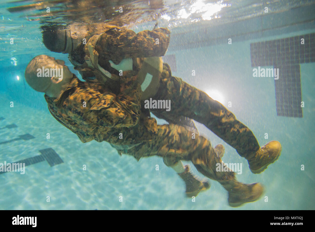 A U.S. Marine Corps Instructor of Water Survival (MCWIS), with water ...