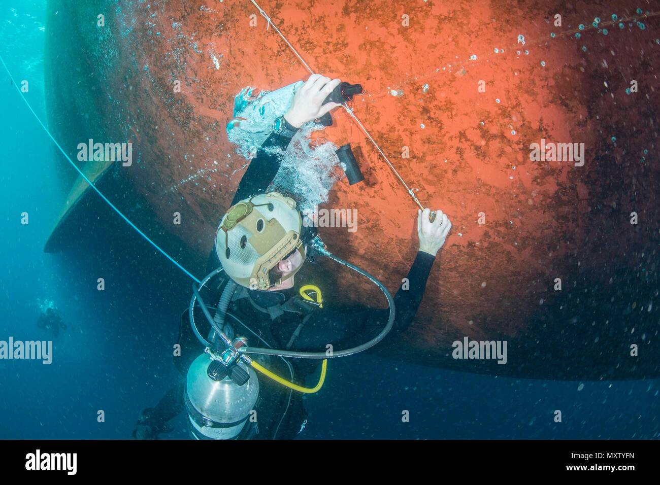 A member of Explosive Ordnance Disposal Mobile Unit (EODMU) 5 conducts ...