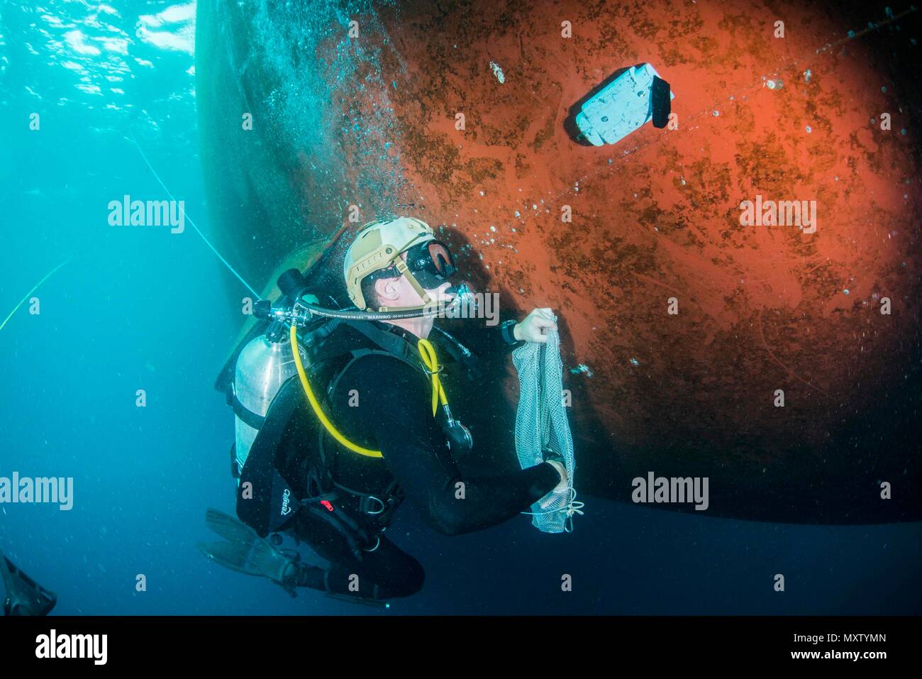 A member of Explosive Ordnance Disposal Mobile Unit (EODMU) 5 conducts ...