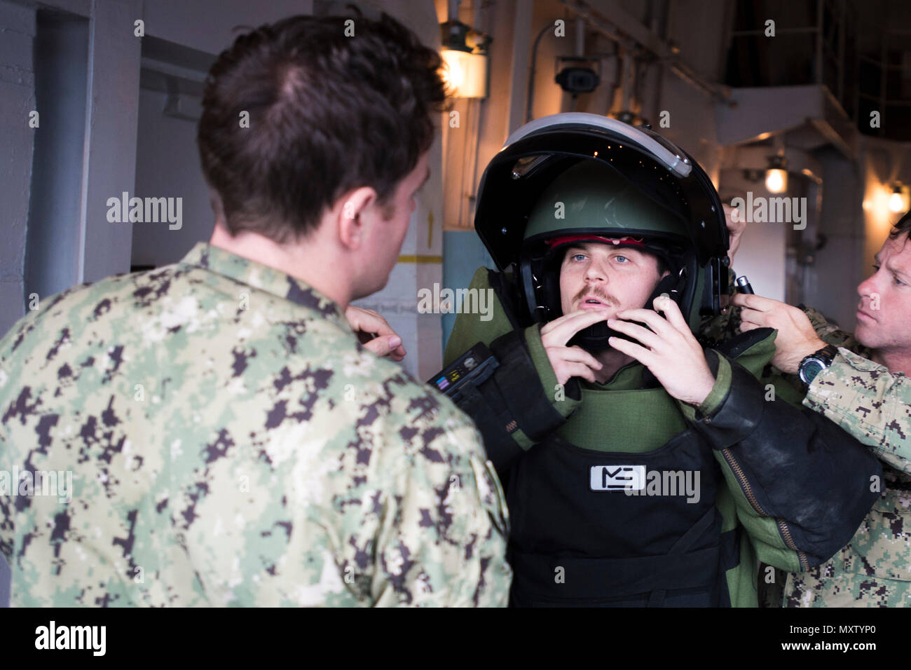 A member of Explosive Ordnance Disposal Mobile Unit (EODMU) 5 dons an ...
