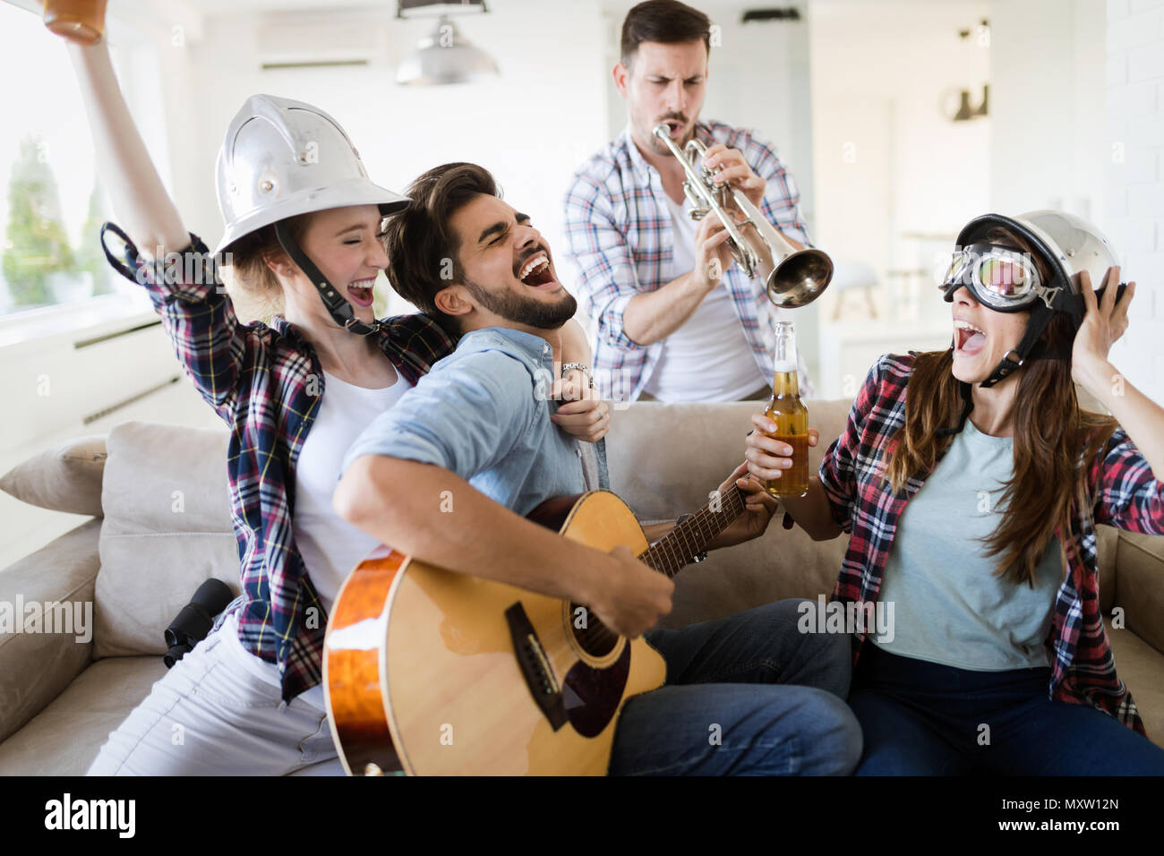 Friends having fun and partying in house and playing music Stock Photo ...