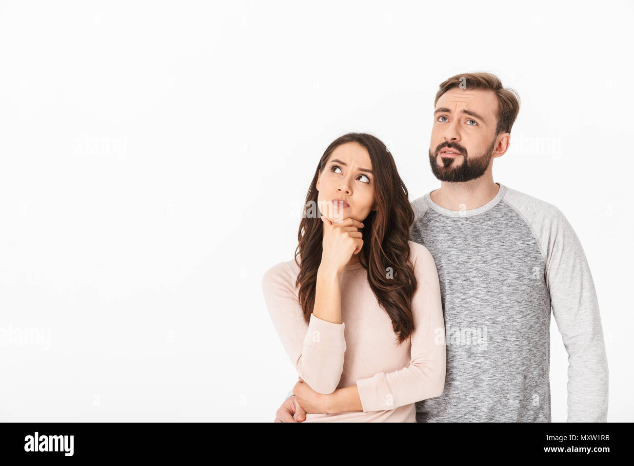 Image of serious thinking young loving couple isolated over white wall ...