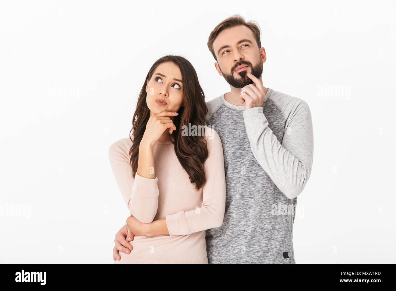 Image of serious thinking young loving couple isolated over white wall ...