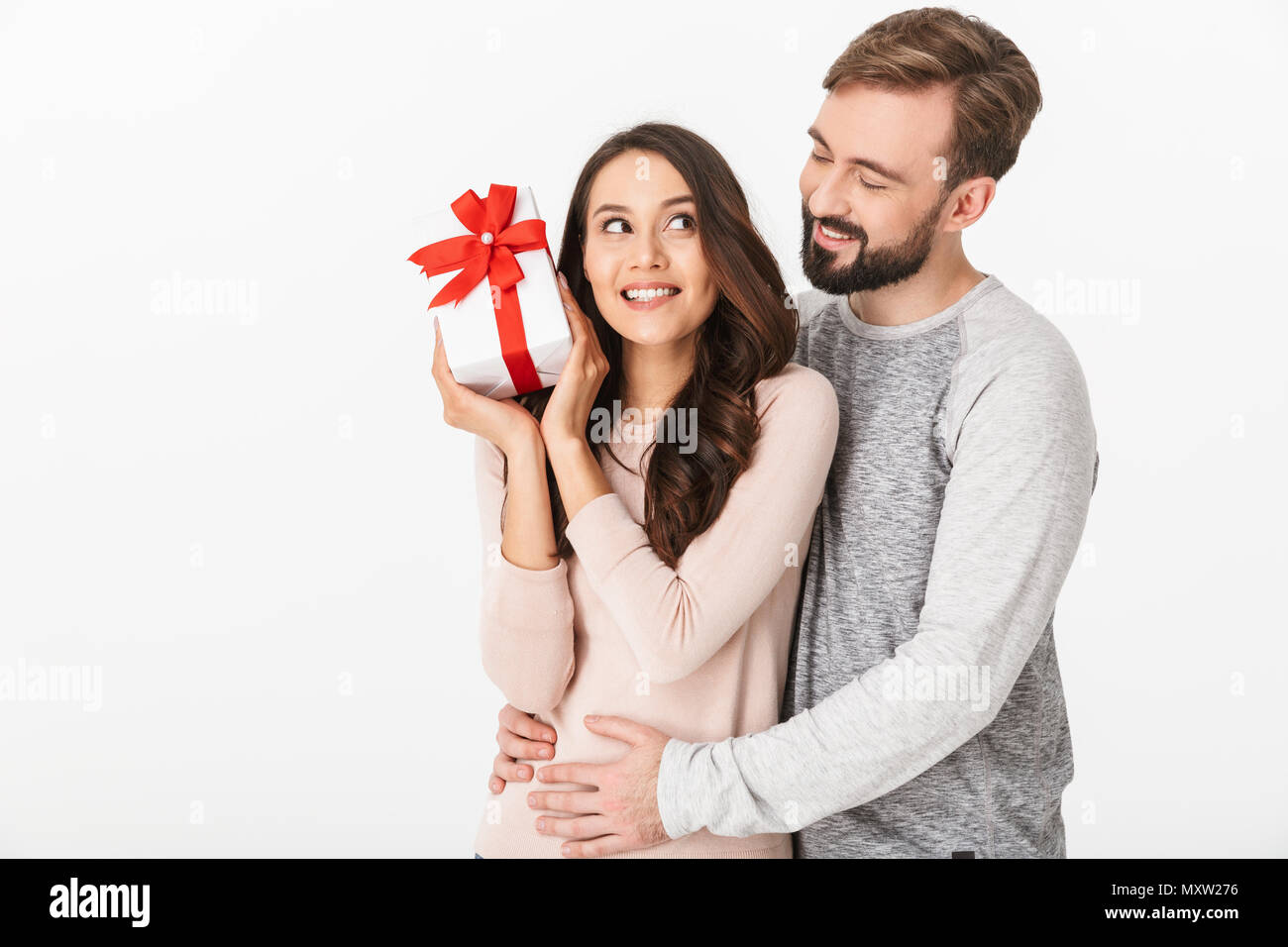 Photo of happy young loving couple standing isolated over white ...