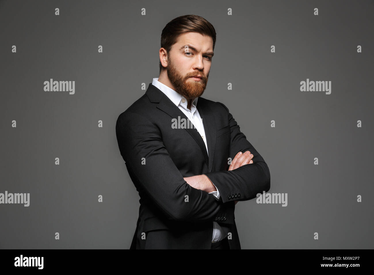 Young man suit grey arms folded hi-res stock photography and images - Alamy