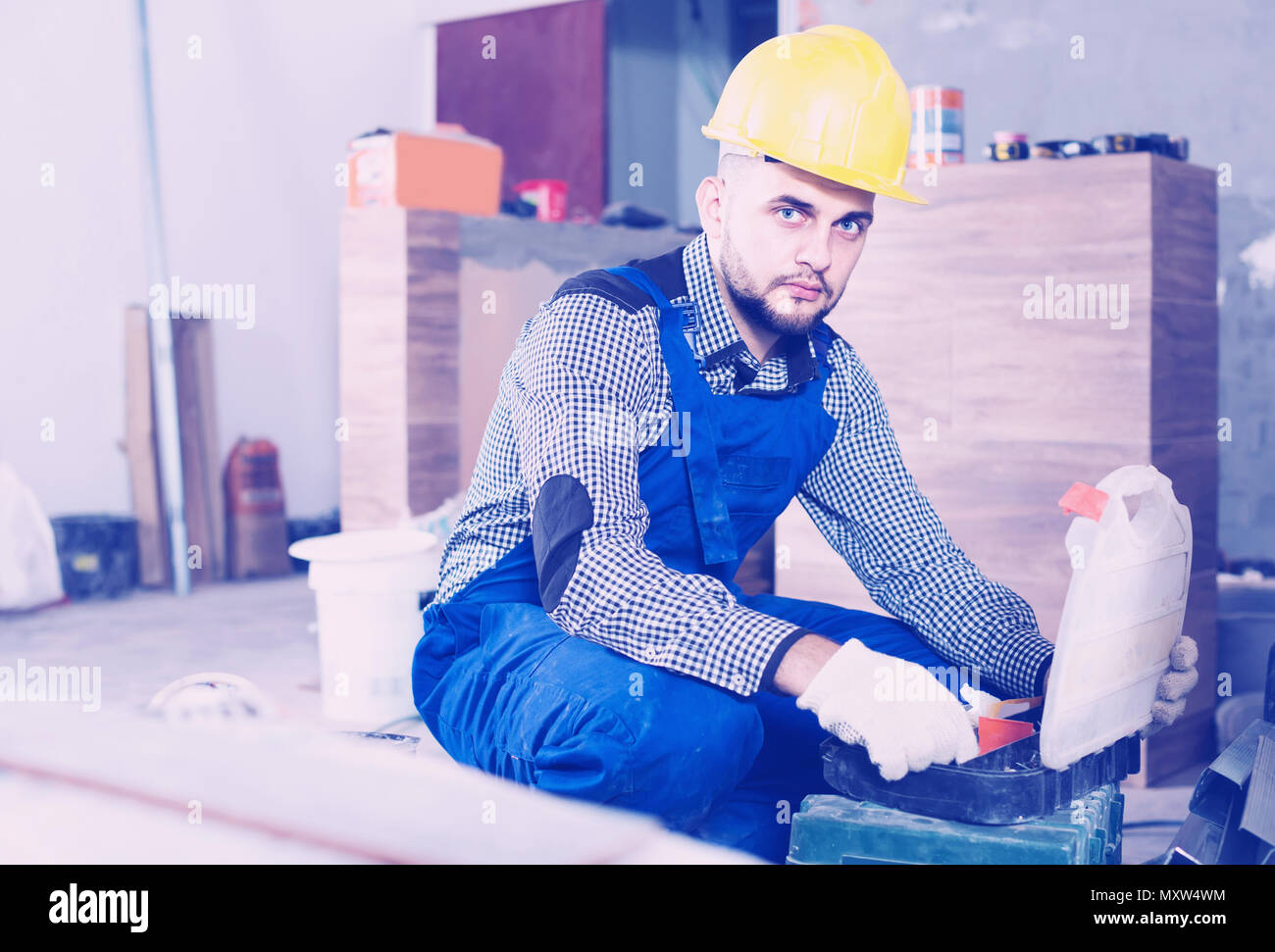 happy germany worker is choosing tools in suitcase for work at the ...