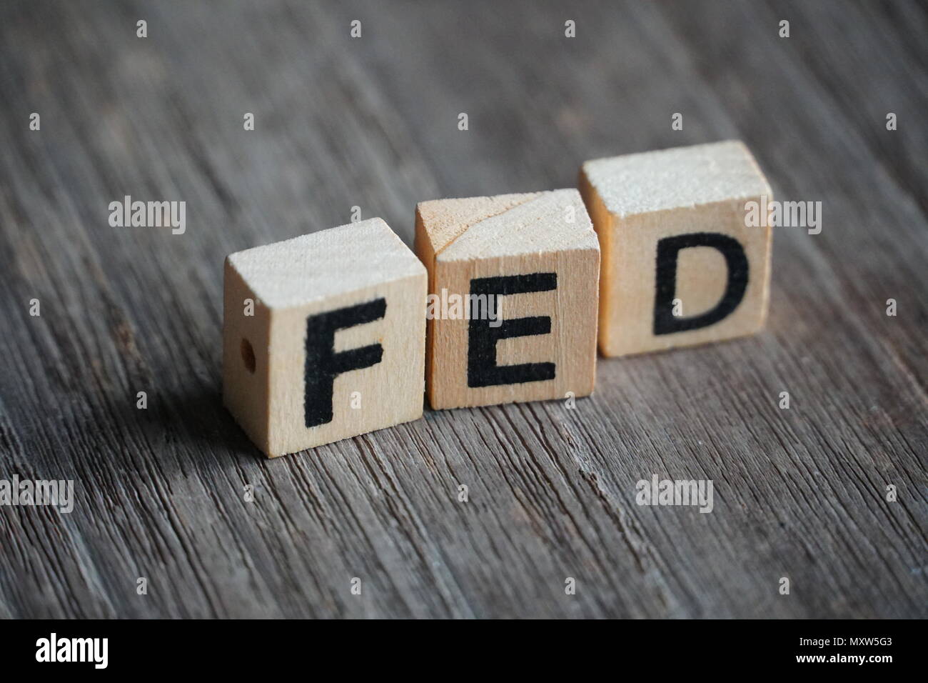 Word "FED"on cube dice on wood table Stock Photo - Alamy