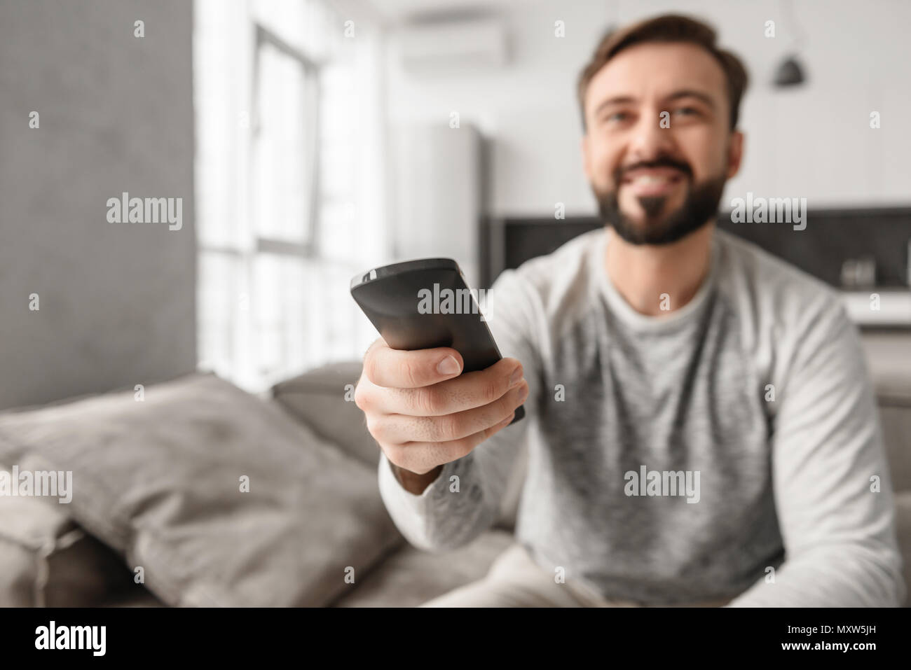 Man holding tv remote hi-res stock photography and images - Alamy
