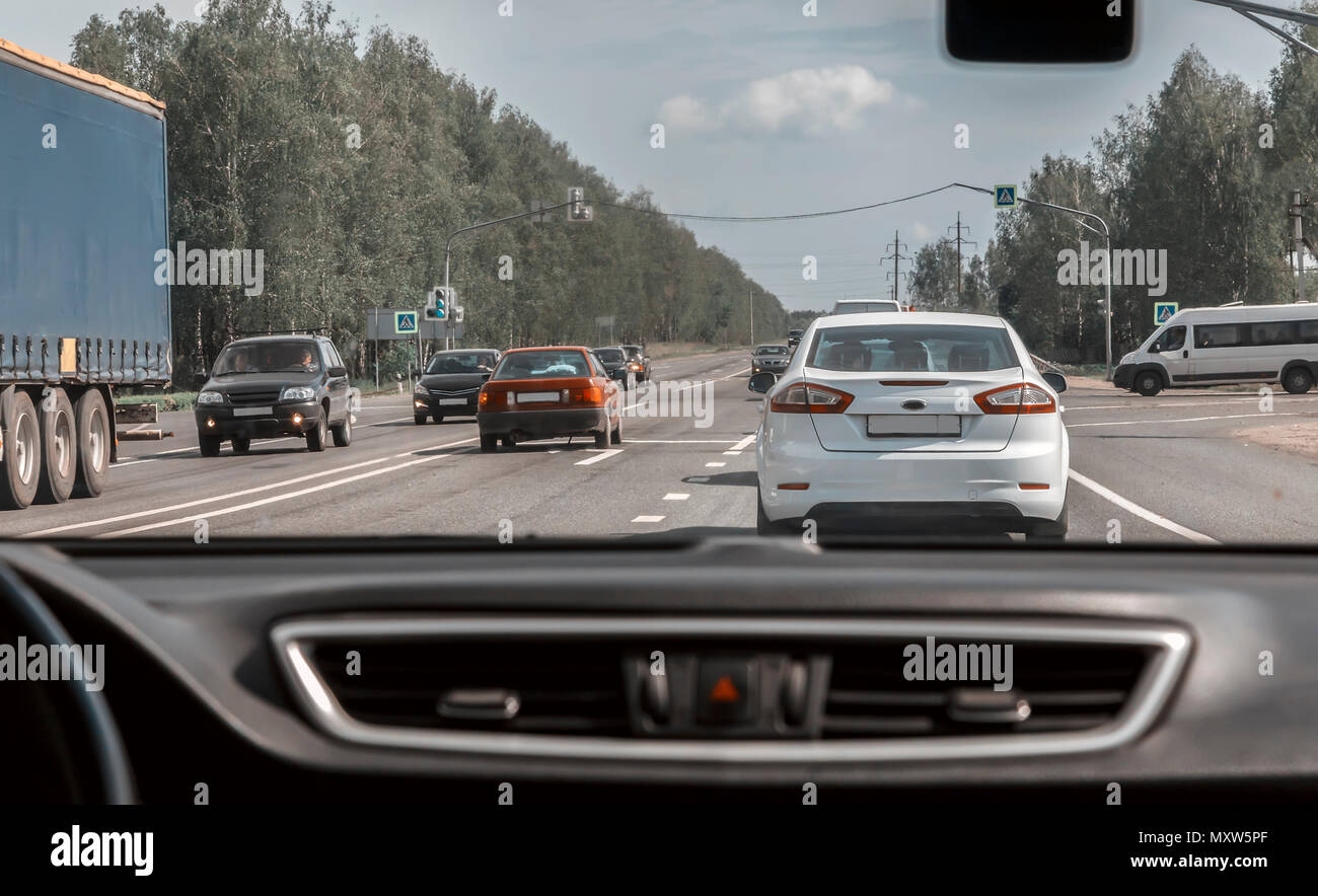 From the front window of the car is visible wide road with two-way ...