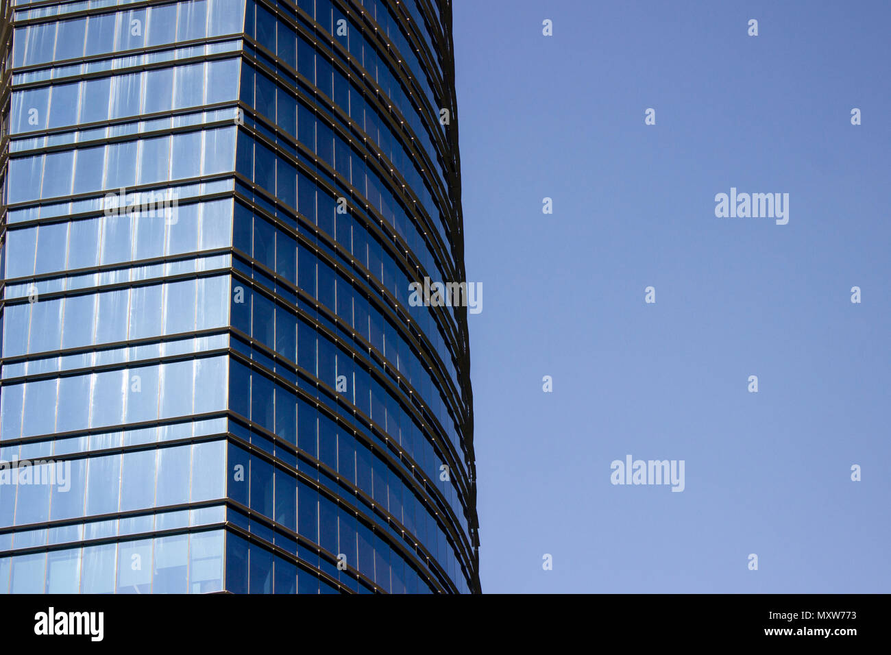 Side view of a striped blue glass window wall of a corporate building ...