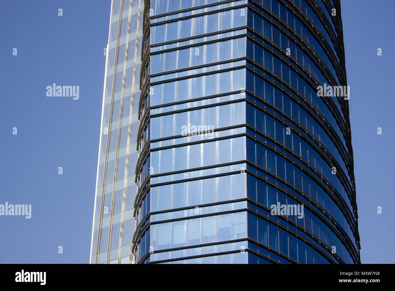 Side view of a blue modern corporate building composed of two high-rise ...