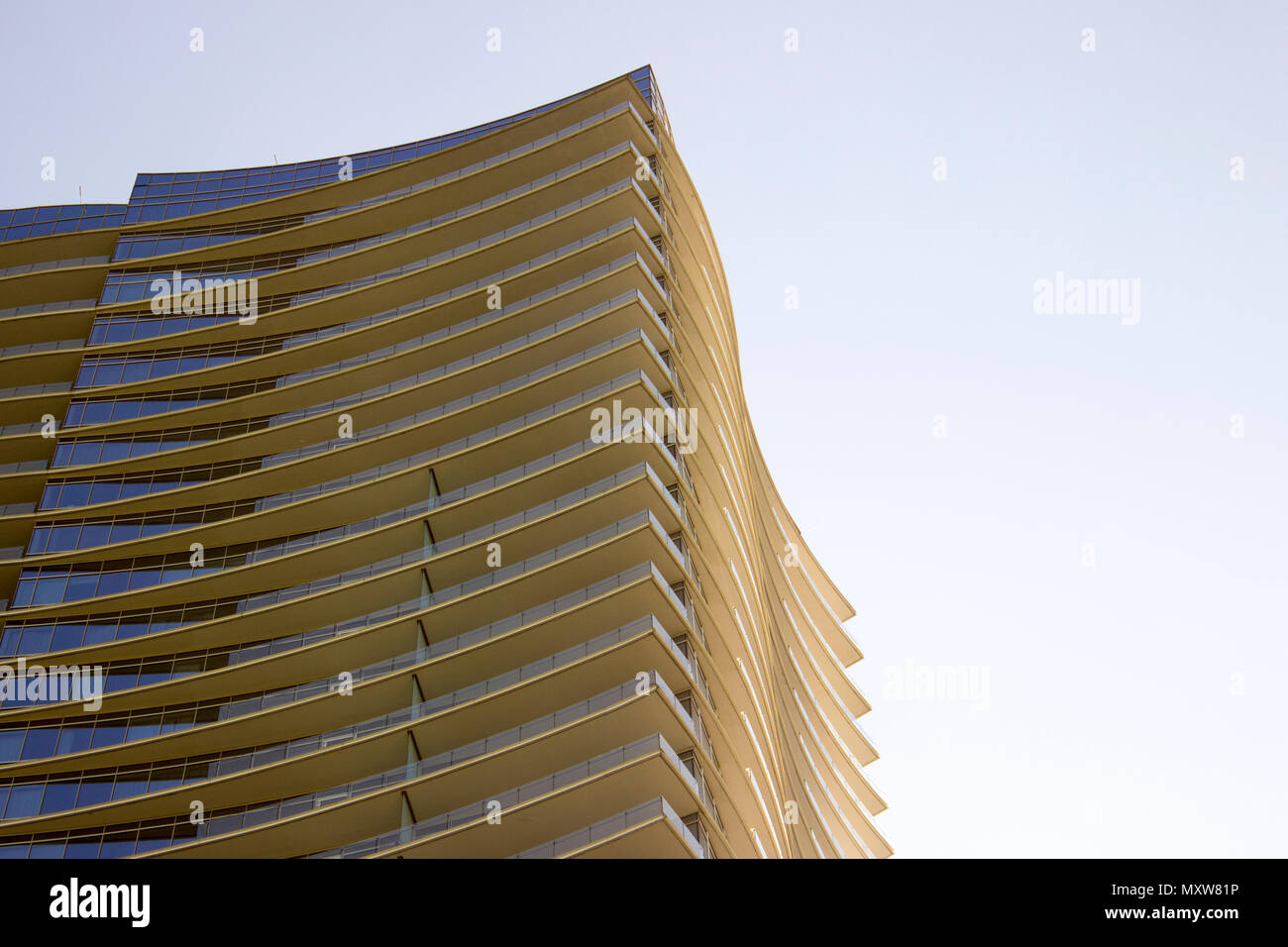 Side view of the top part of a modern corporate building with yellowish ...