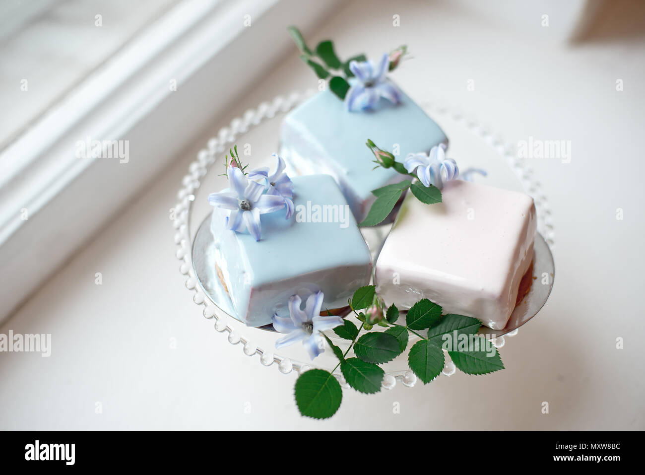 square form mirror glazed cakes in crystal vase Stock Photo - Alamy