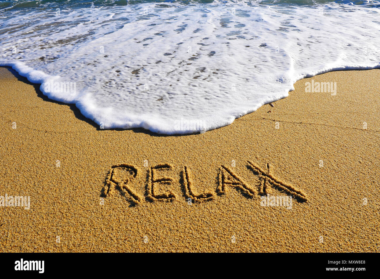 Relax sign on the sand beach, summer background Stock Photo - Alamy