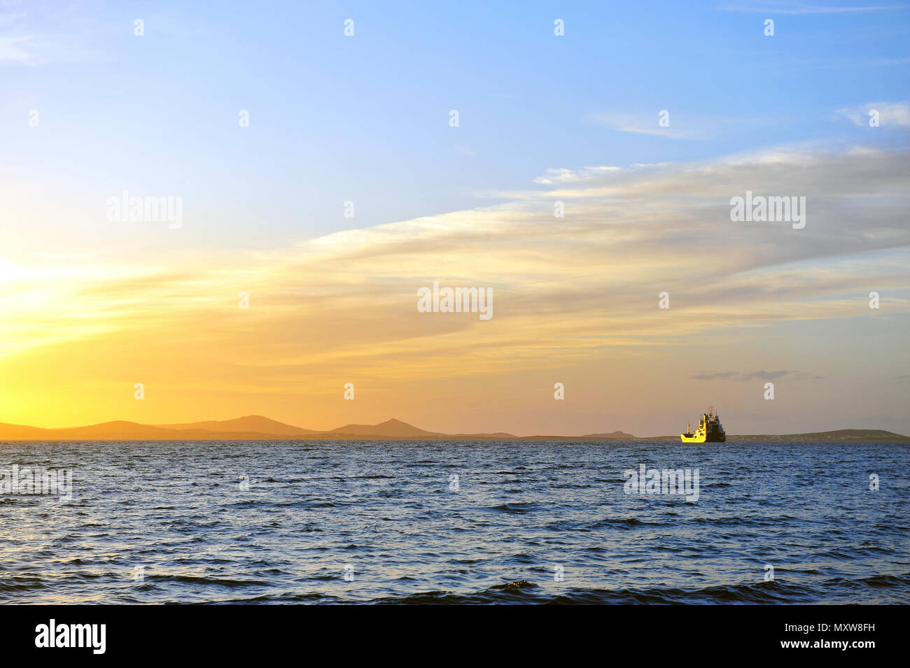 Nautical vessel at horizon in the deep blue water Stock Photo - Alamy