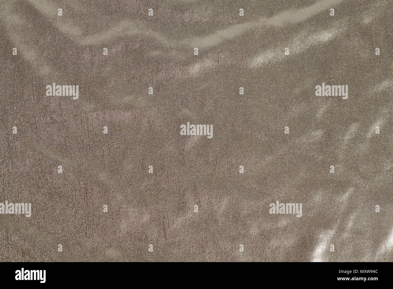 Golden brocade fabric waves background close up Stock Photo - Alamy