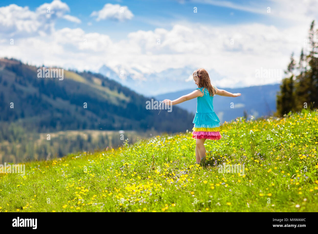 Children hiking in Alps mountains. Kids look at snow covered mountain ...