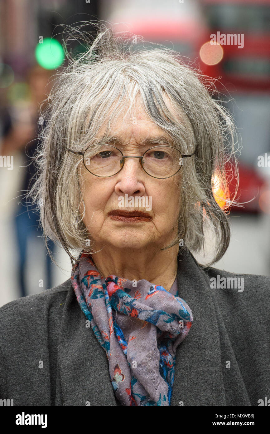 Artist Rose Wylie pictured on Piccadilly in London, in front of flags ...