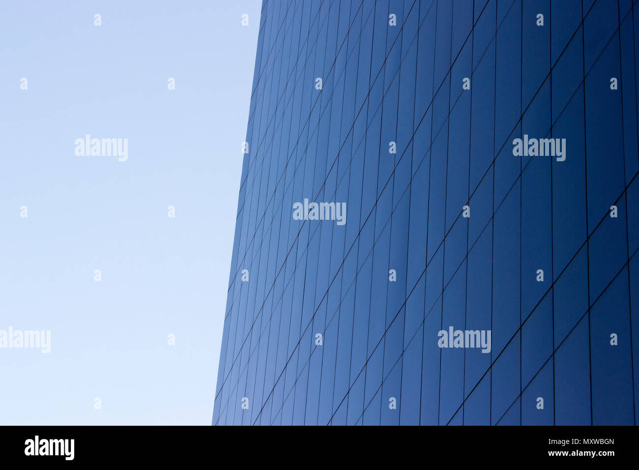 Side view of a smooth blue glass window wall of an office building ...