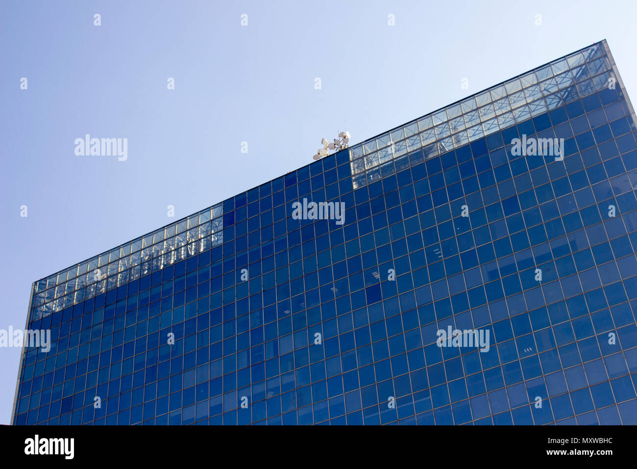 Top part of a glass window wall of an office building Stock Photo - Alamy