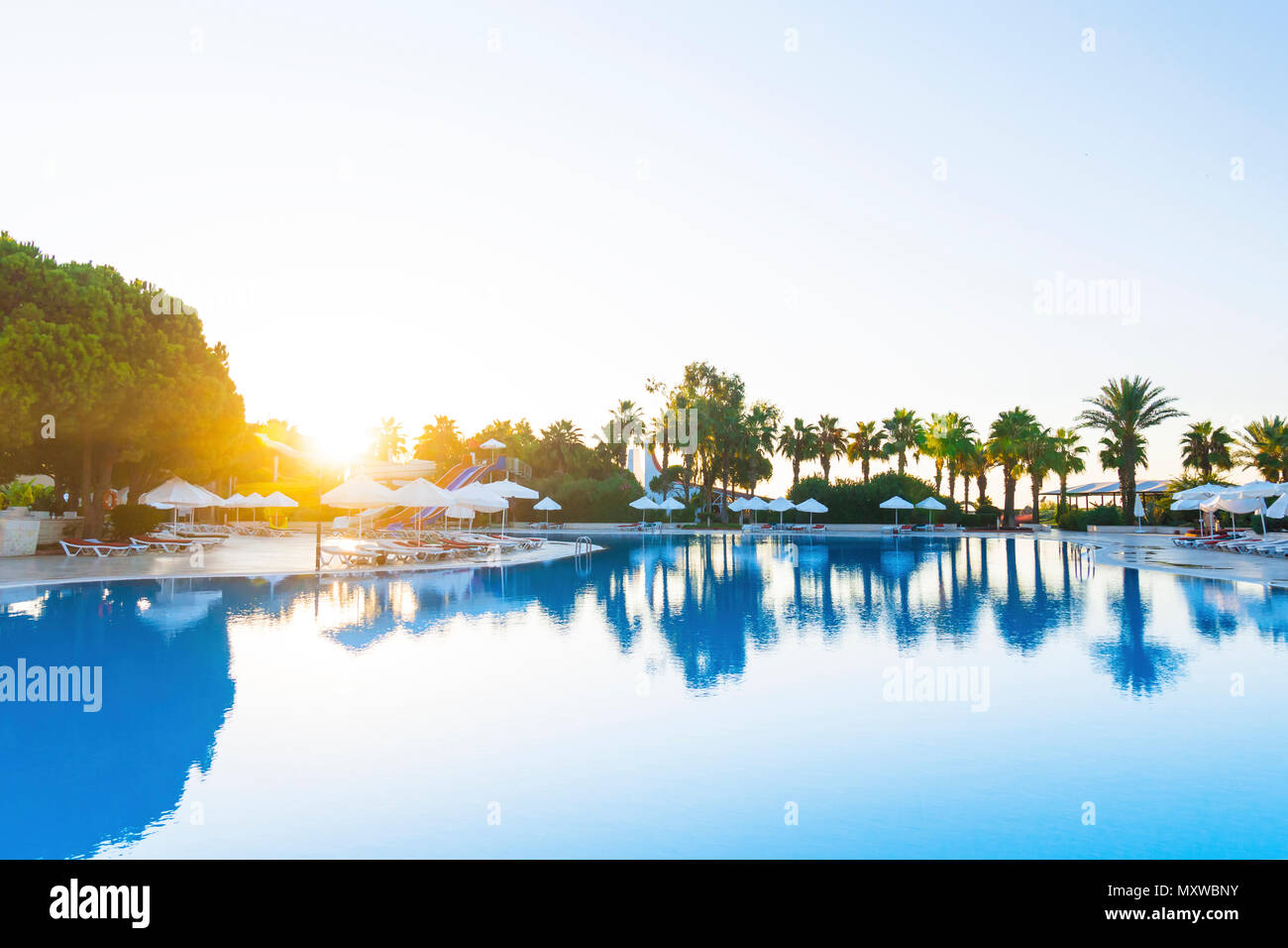 Beautiful sunrise at the pool with clear blue water Stock Photo - Alamy