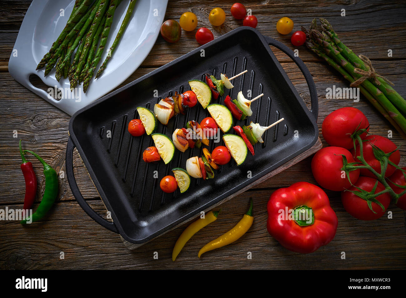 brochette vegetable on grill pan with tomato onion pepper zucchini ...