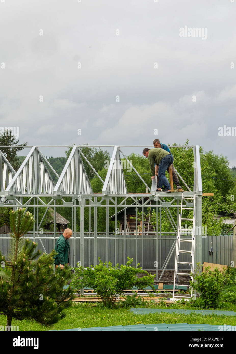 Caucasian man performs roofing work Stock Photo - Alamy