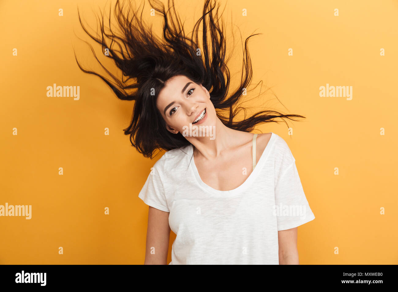 Photo of happy excited young pretty woman shaking hair standing ...