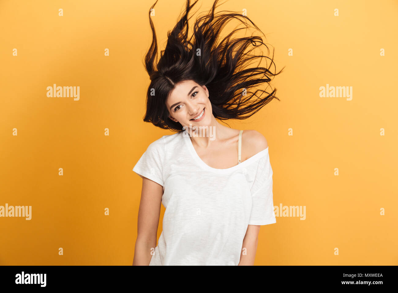 Photo of happy excited young pretty woman shaking hair standing ...