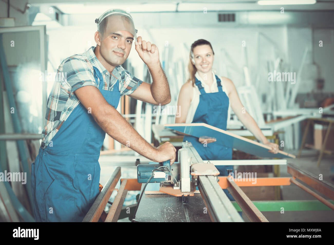 Worker male is ready to work on circular saw in assembly shop with his ...