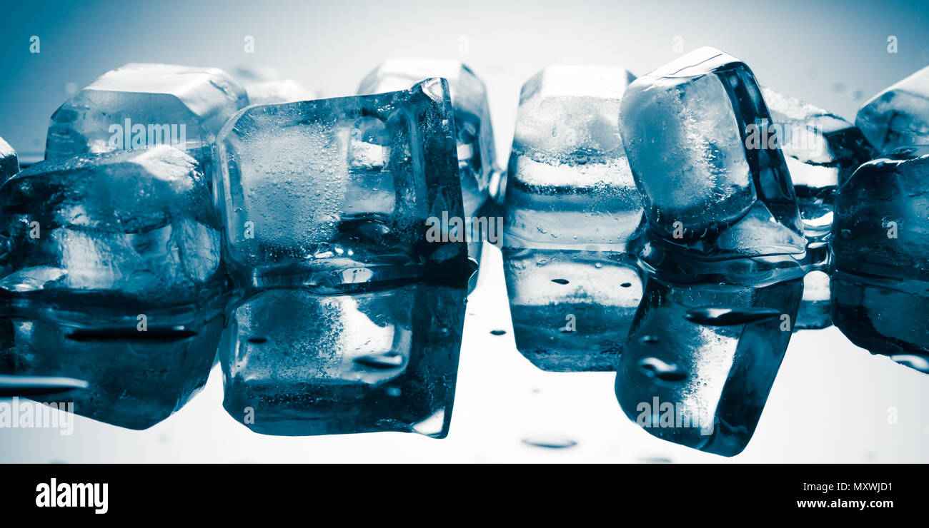 pile of different ice cubes on reflection table Stock Photo - Alamy