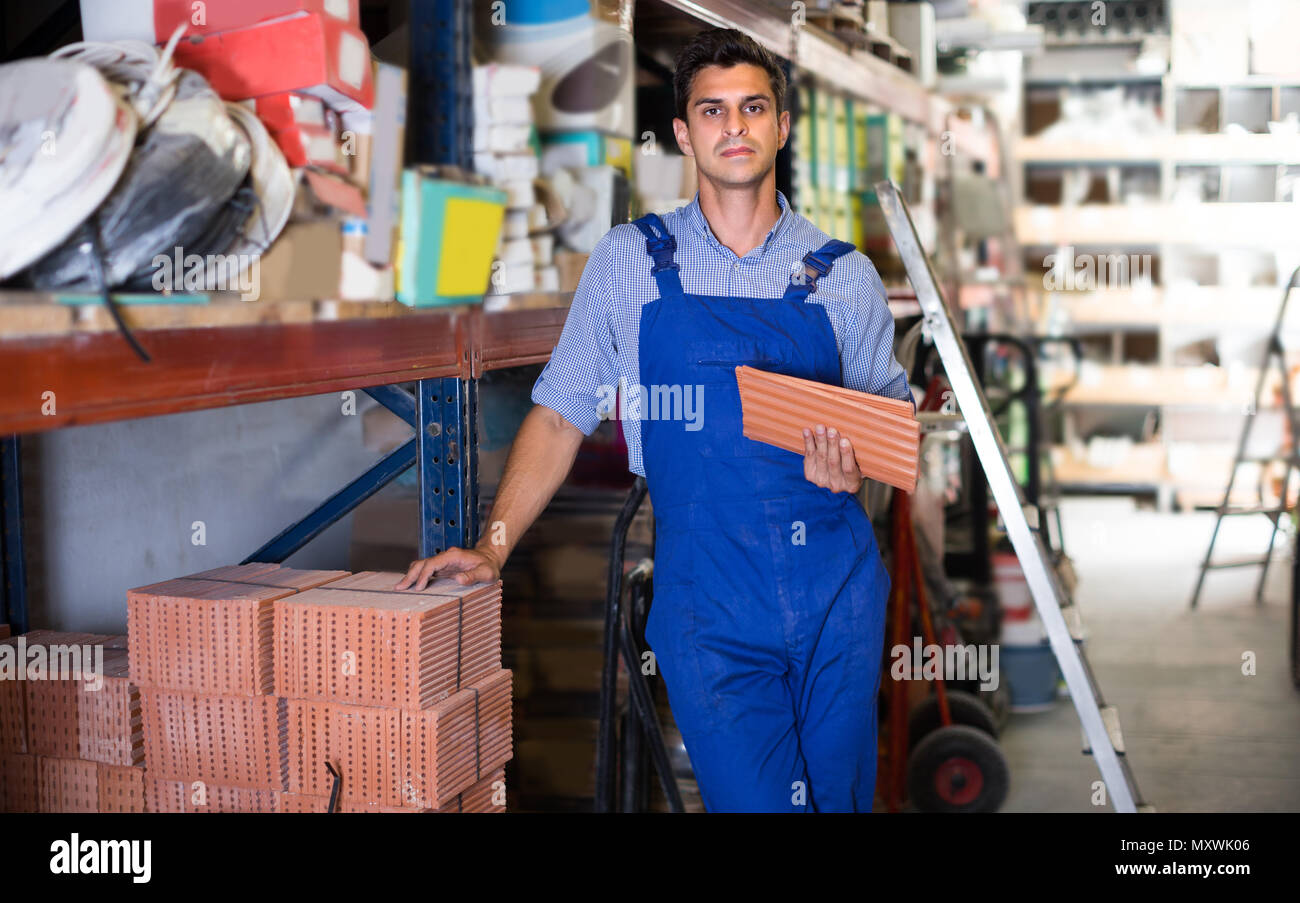 Foreman is choosing tiles in the building store Stock Photo - Alamy