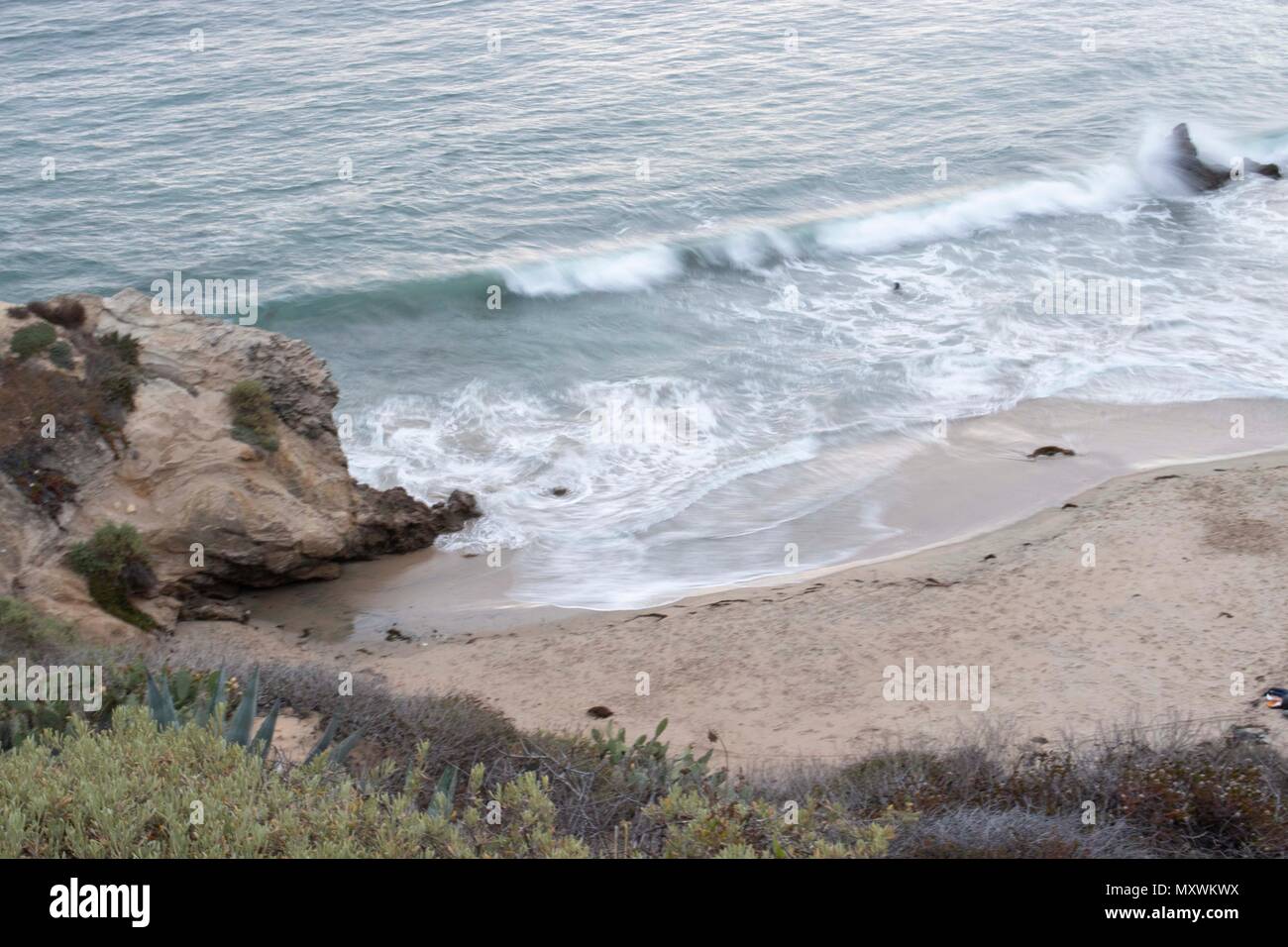 Waves crashing at the beach Stock Photo - Alamy