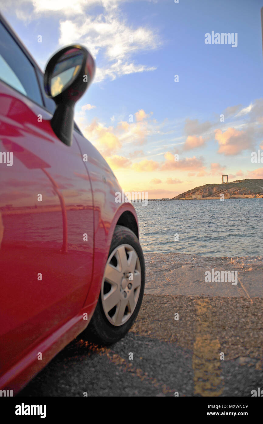 Red mini car with ancient arch on background Stock Photo - Alamy