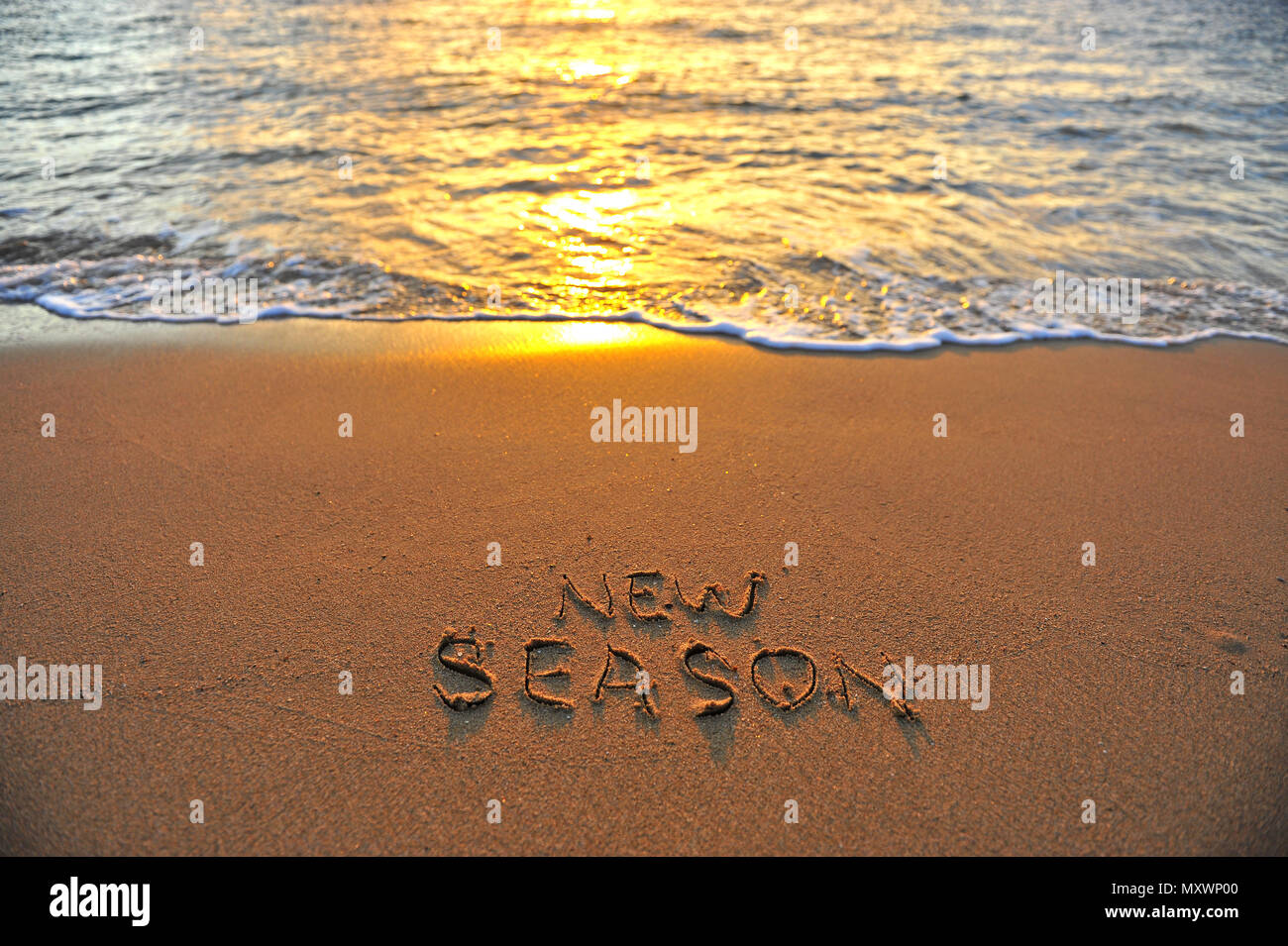 New season sign on sand beach Stock Photo - Alamy