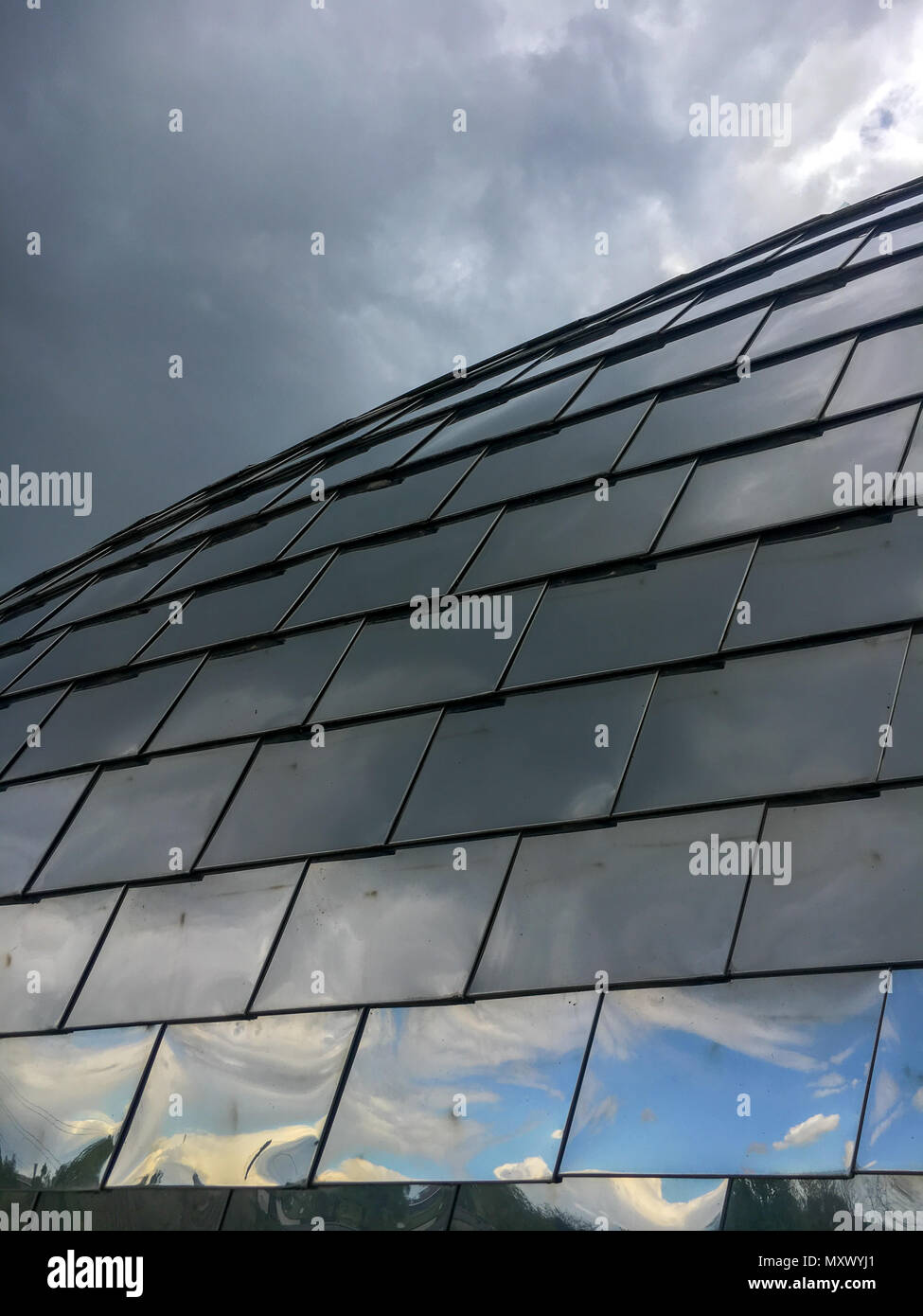 Modern roof reflecting clouds and partly blue sky Stock Photo - Alamy
