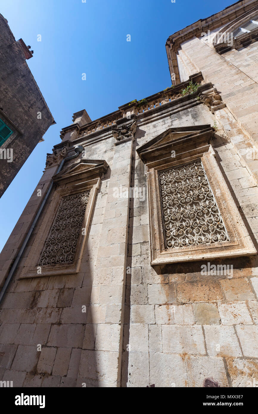 Detail of carvings inside a stone window frame in an alley in Dubrovnik ...