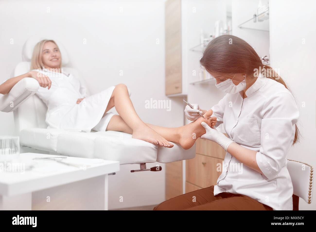 Podiatrist doctor cleaning foot from callus Stock Photo - Alamy