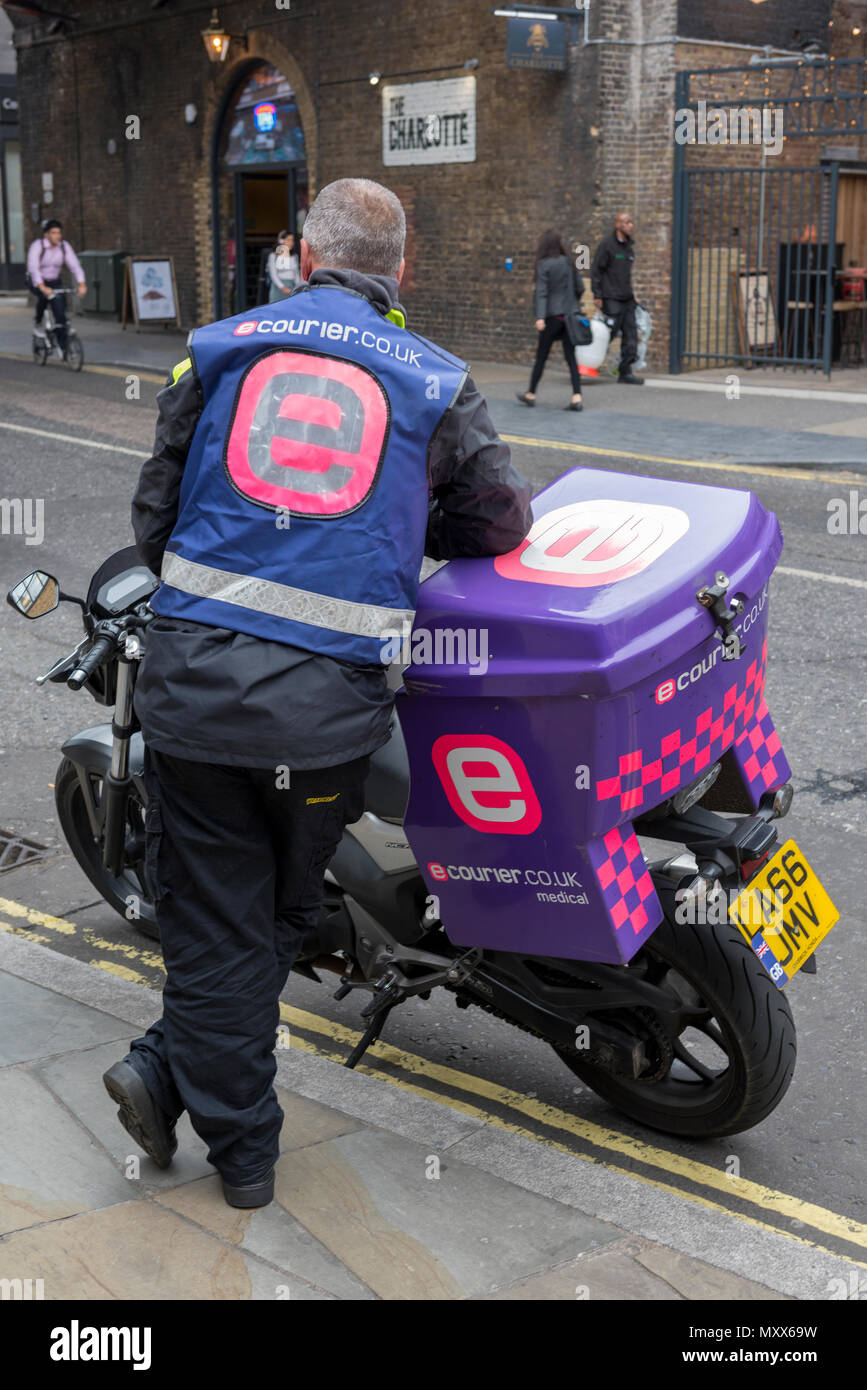 a motorcyclist in central london working for private courier company ...
