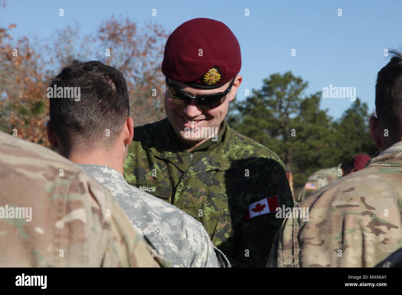 Capt. Andrew Adach, Canadian Army Advanced Warfare Center, pins a ...