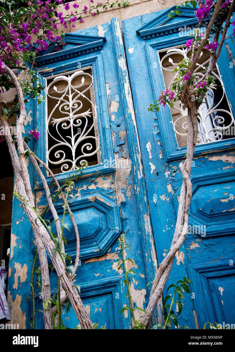 beautiful old derelict double door, bright blue flaking paintwork ...