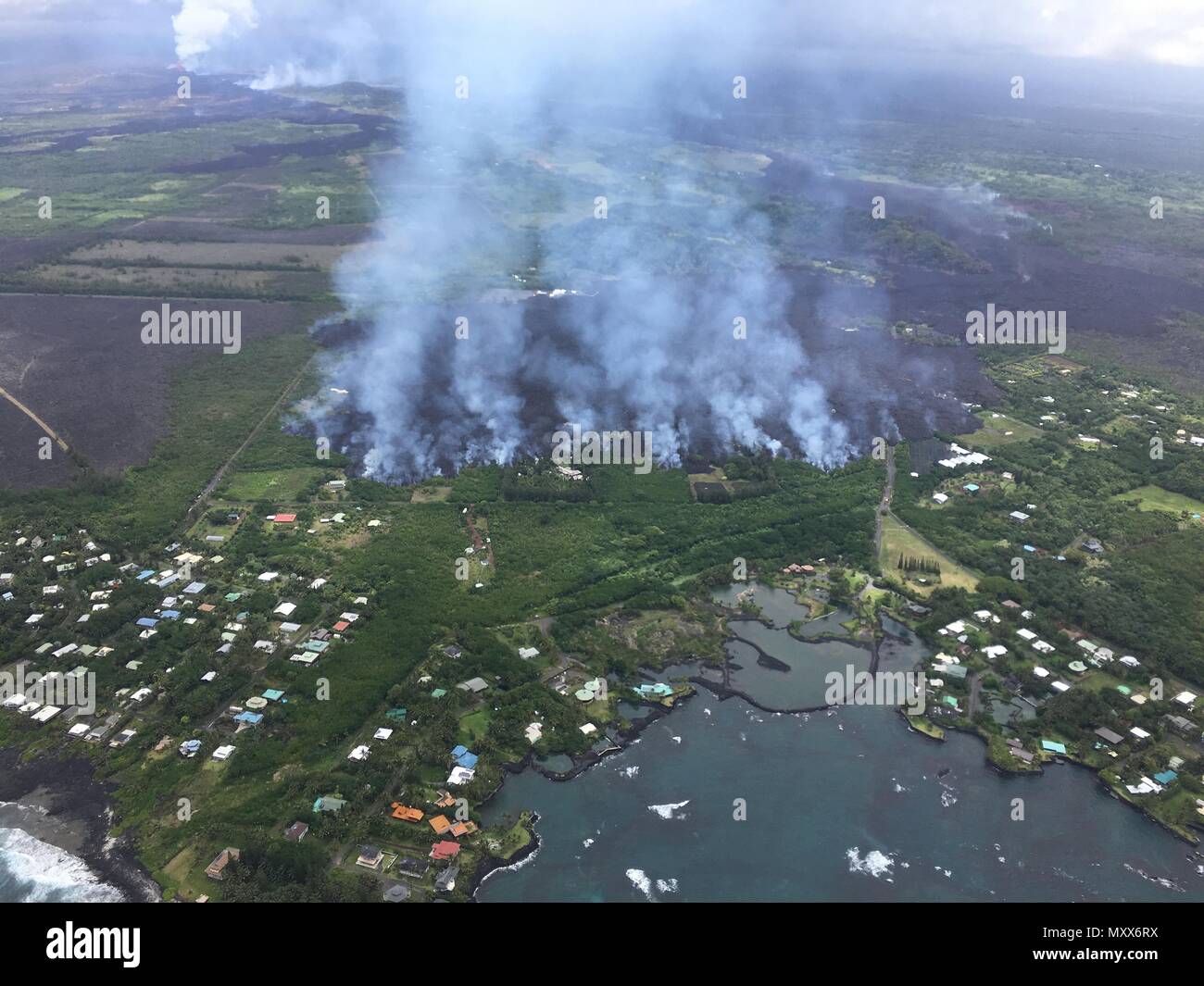 Lava flows toward the coast destroying forest and homes in the ...
