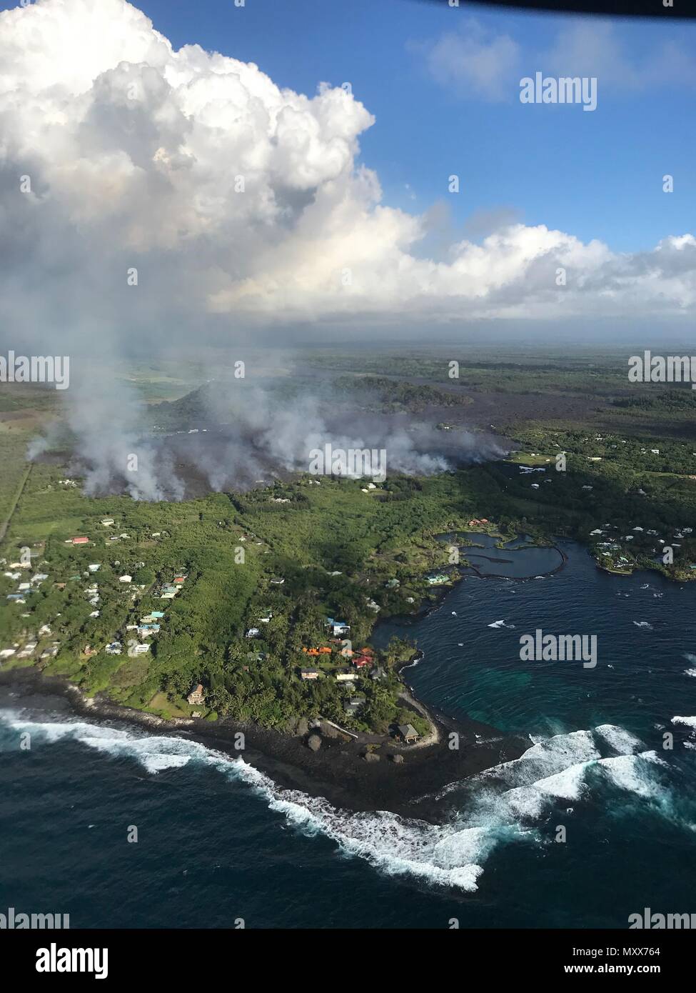 Lava flows toward the coast destroying forest and homes in the ...