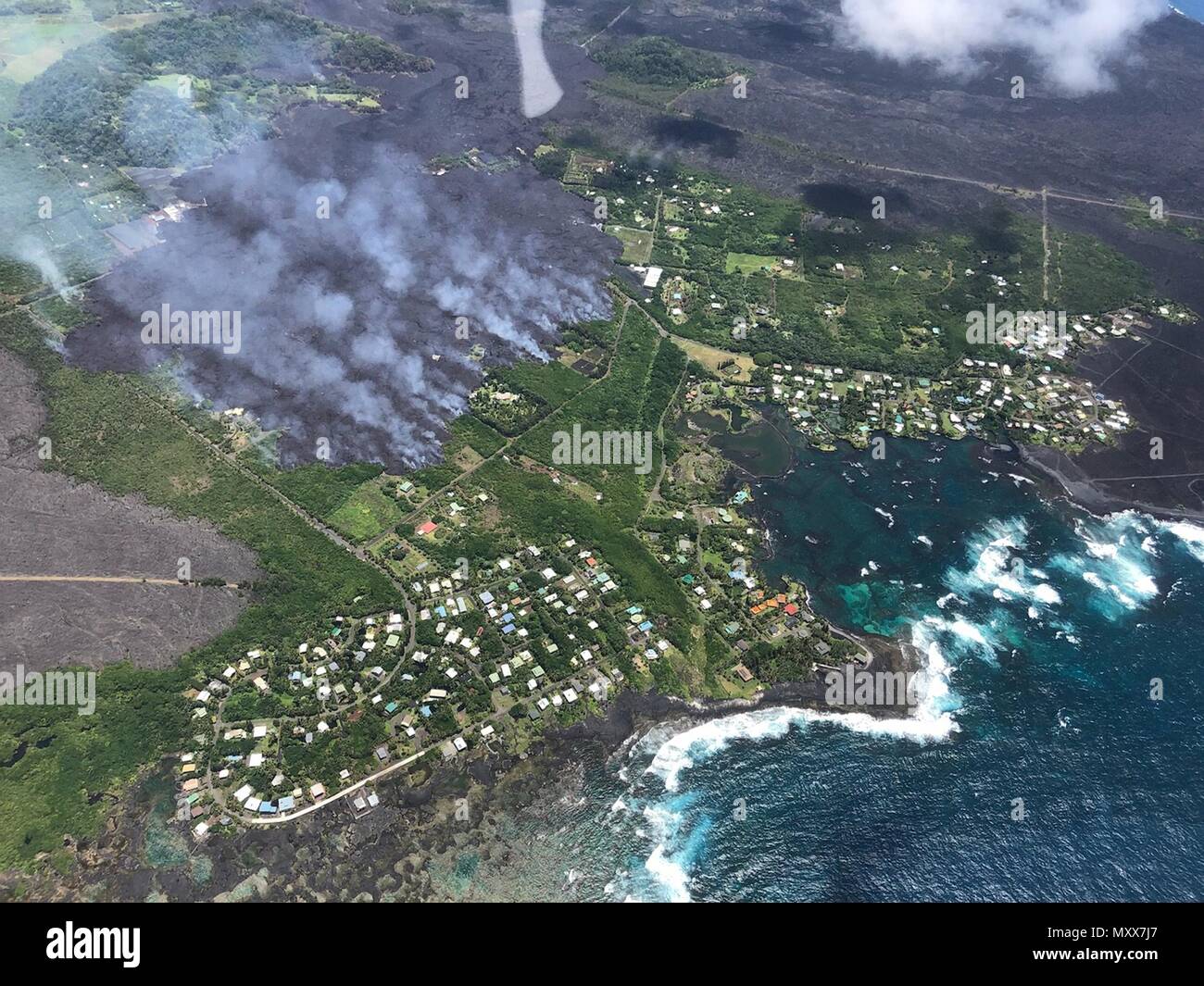 Lava flows toward the coast destroying forest and homes in the ...