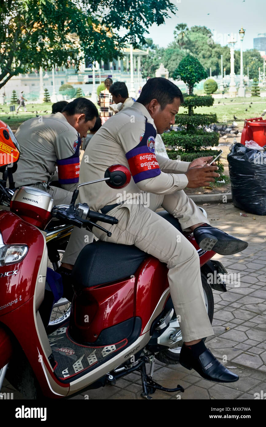 Security Police on cell phones, Phnom Penh, Cambodia Stock Photo - Alamy
