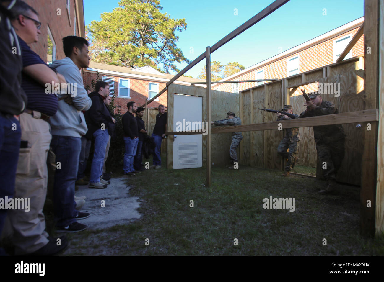 Marines demonstrate proper room-clearing techniques for members of the ...