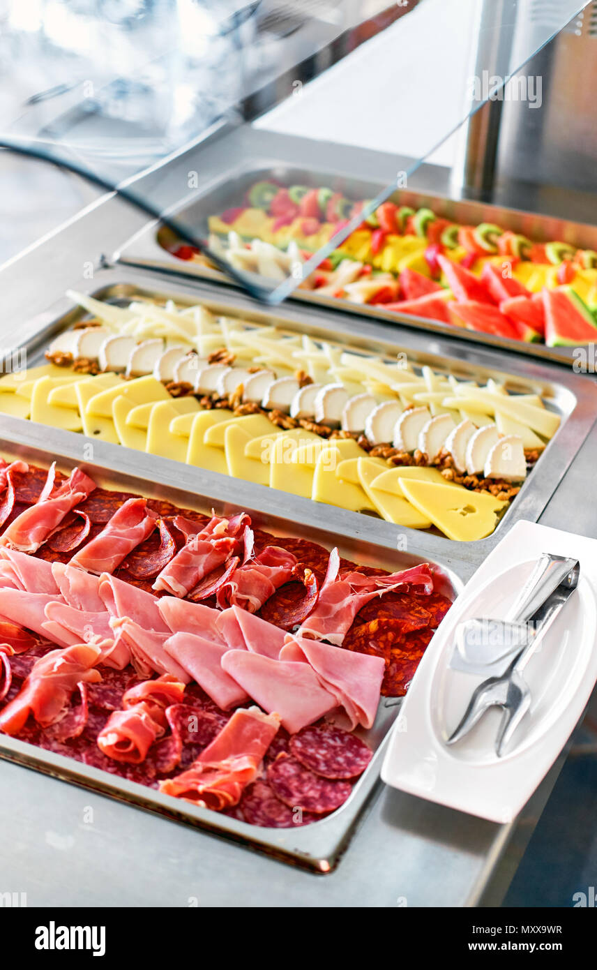 Buffet trays with a various delicious appetizers close-up. Breakfast in ...