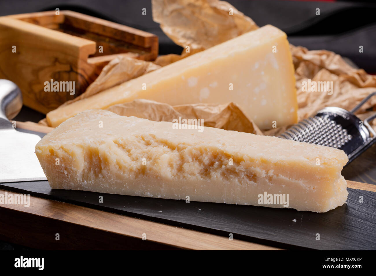 Aged Italian parmesan hard cheese Parmigiano-Reggiano with cheese knife ...
