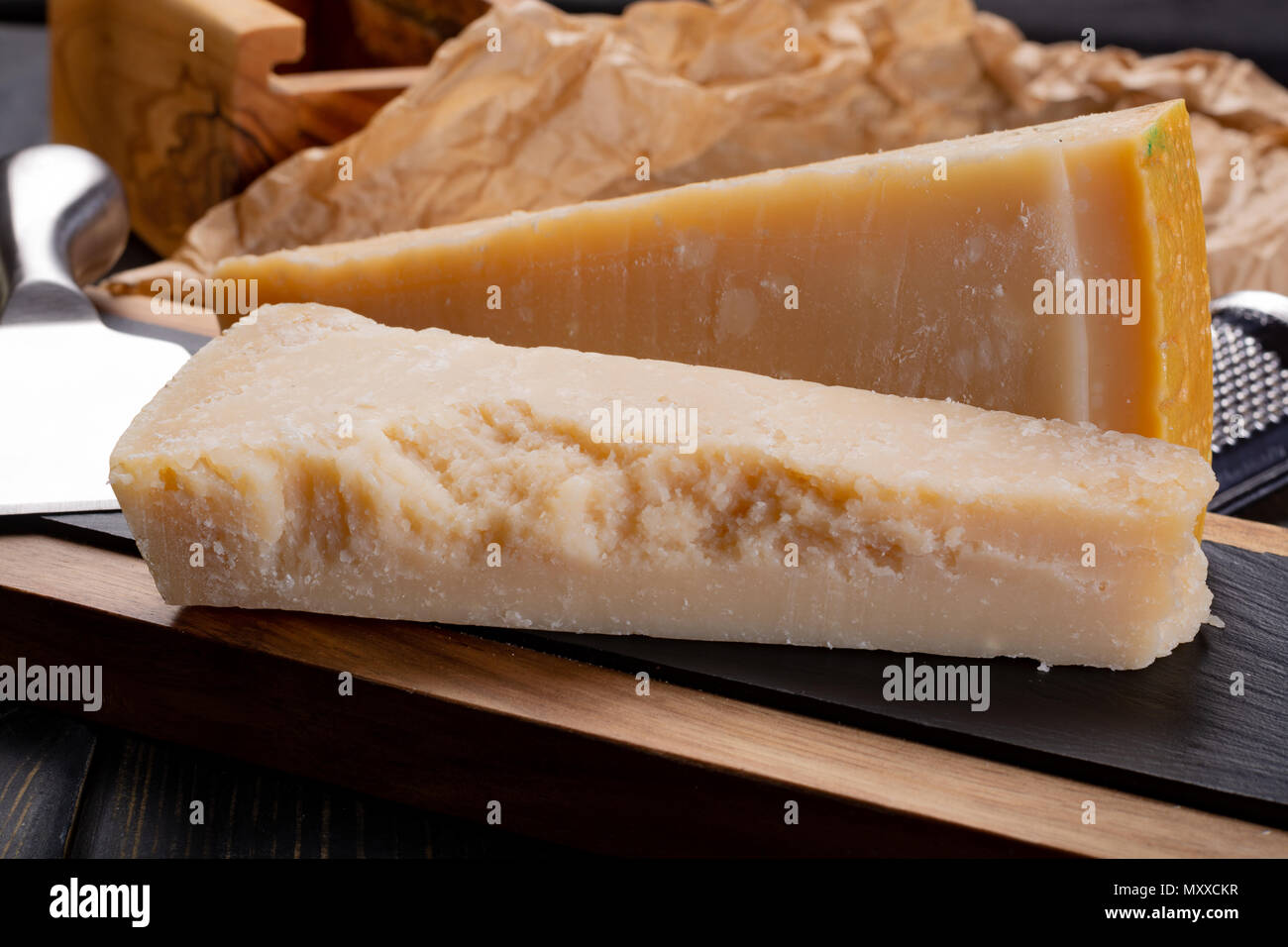 Aged Italian parmesan hard cheese Parmigiano-Reggiano with cheese knife ...
