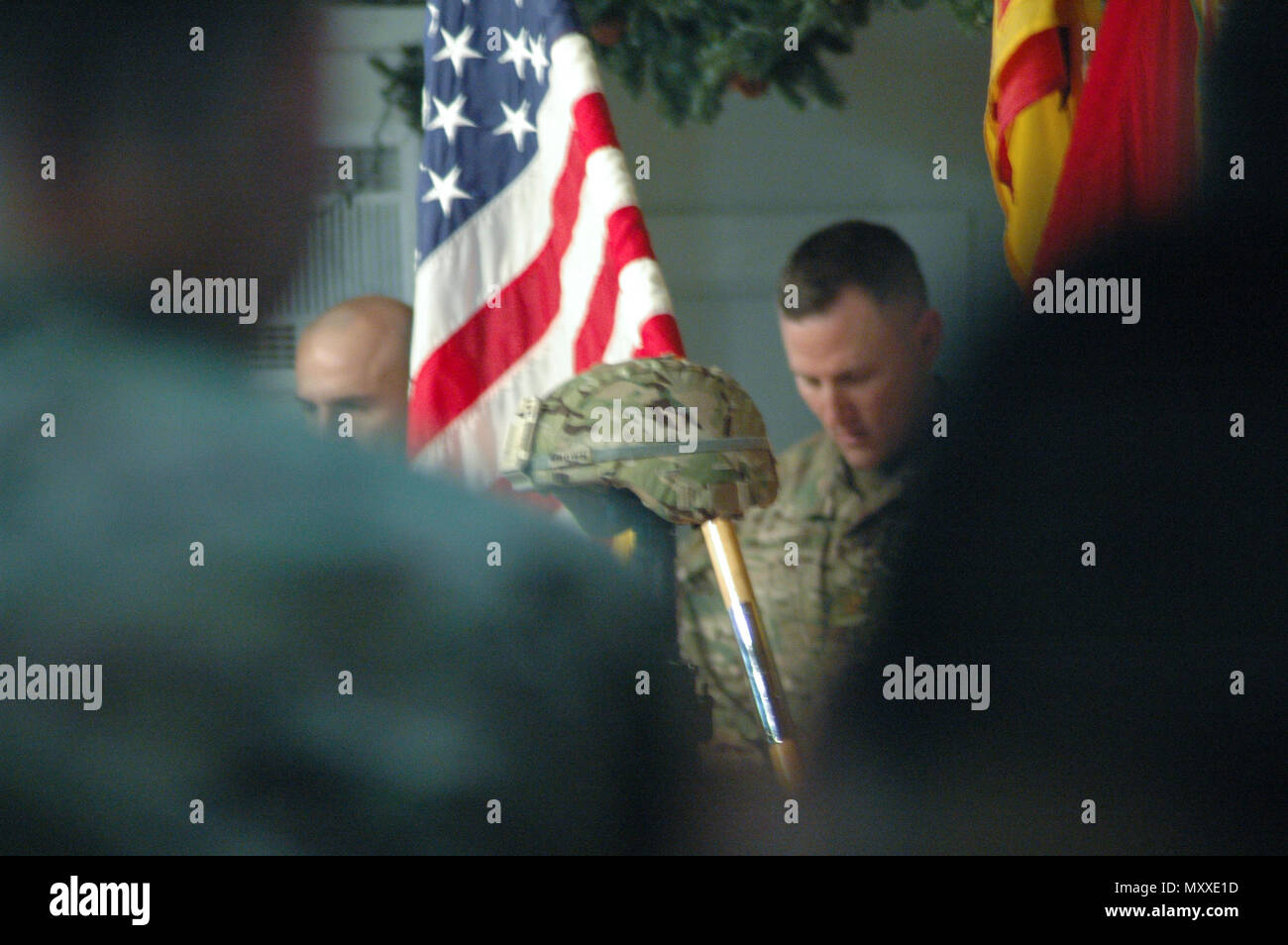 A moment of silence is held at a memorial service hosted by the 1st ...